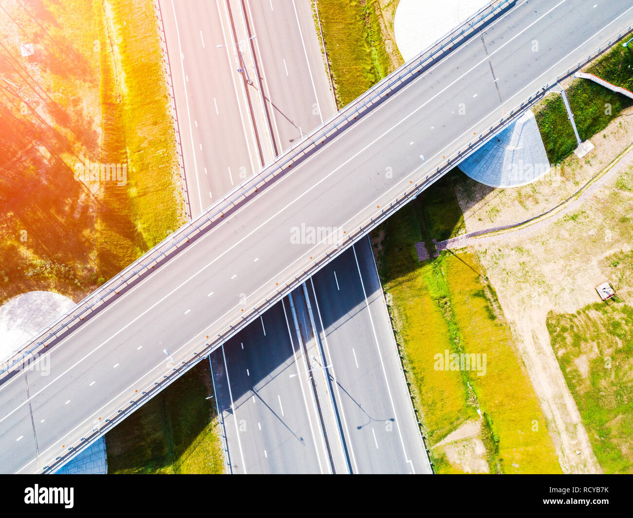 Aerial view of highway in city. Cars crossing interchange overpass. Highway interchange with ...