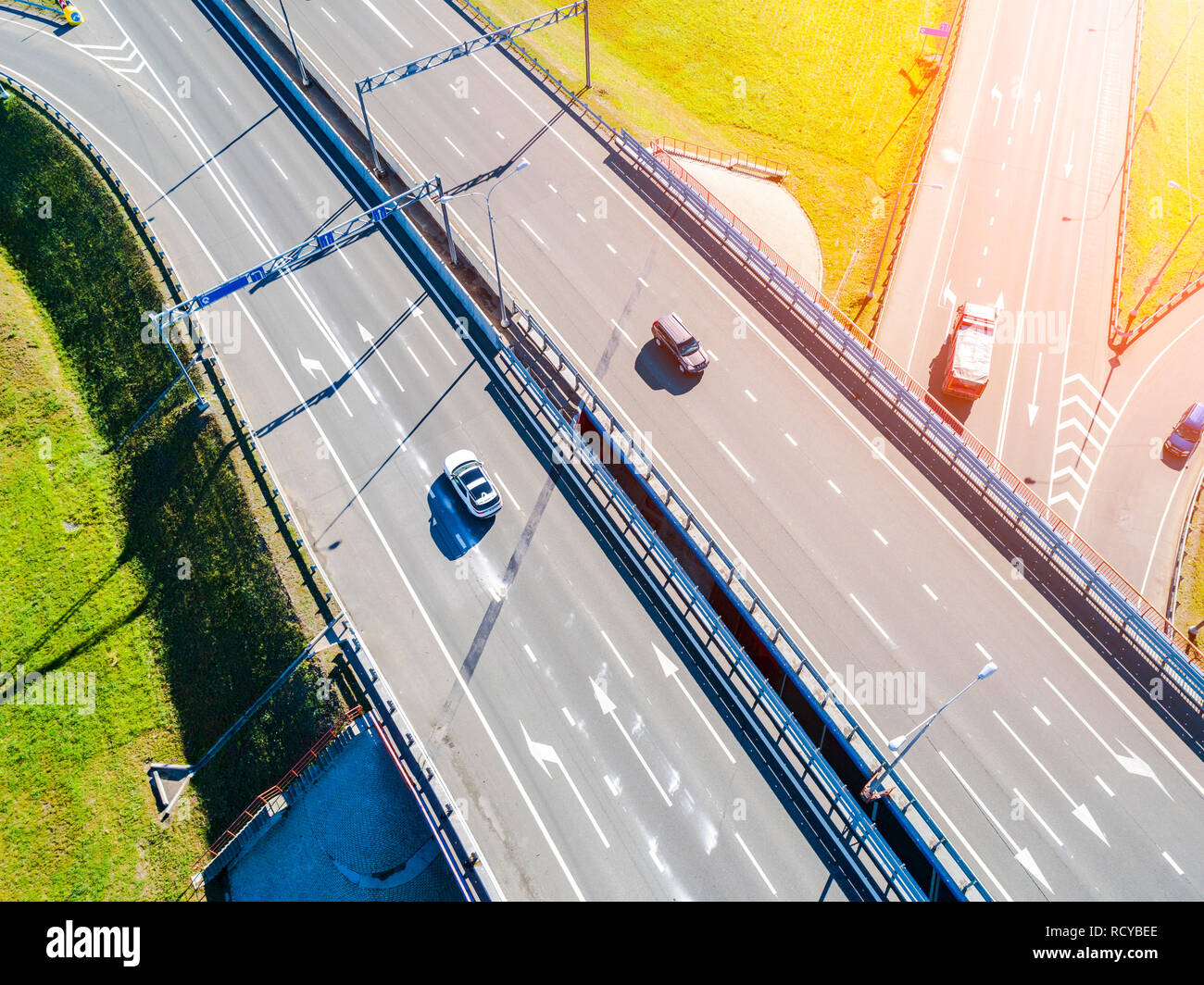 Aerial view of highway in city. Cars crossing interchange overpass. Highway interchange with ...