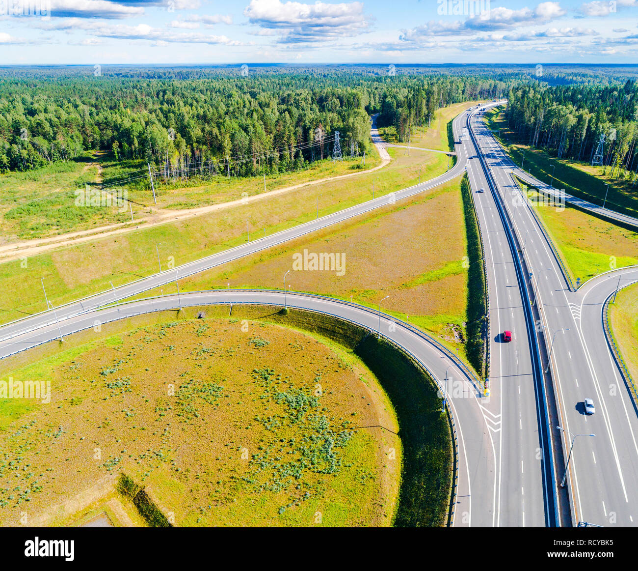 Aerial view of highway in city. Cars crossing interchange overpass. Highway interchange with ...