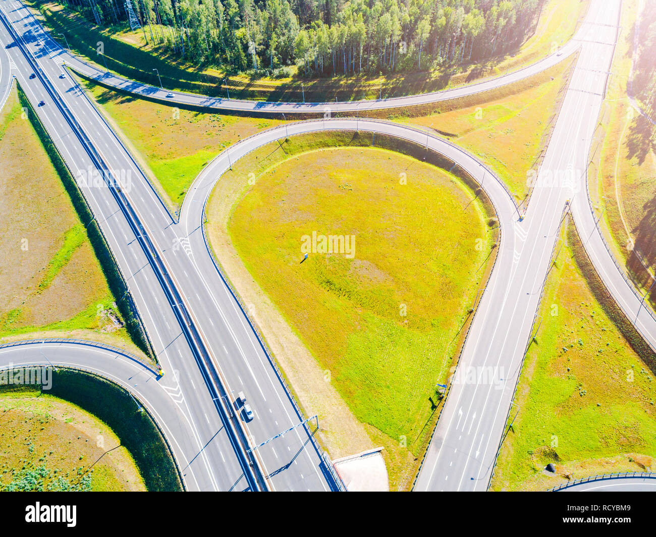 Aerial view of highway in city. Cars crossing interchange overpass. Highway interchange with ...