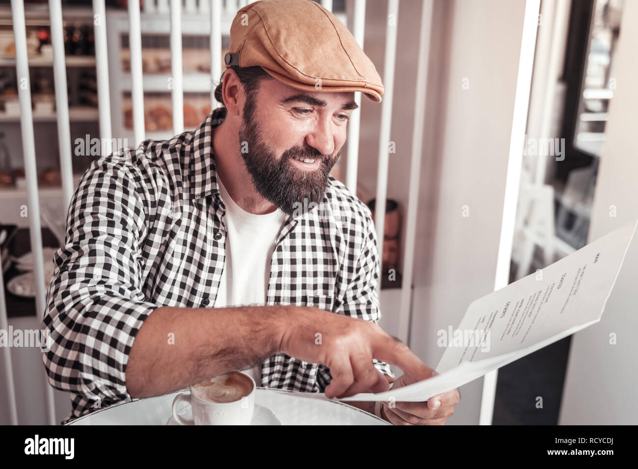 Man making a choice from the cafe menu Stock Photo - Alamy