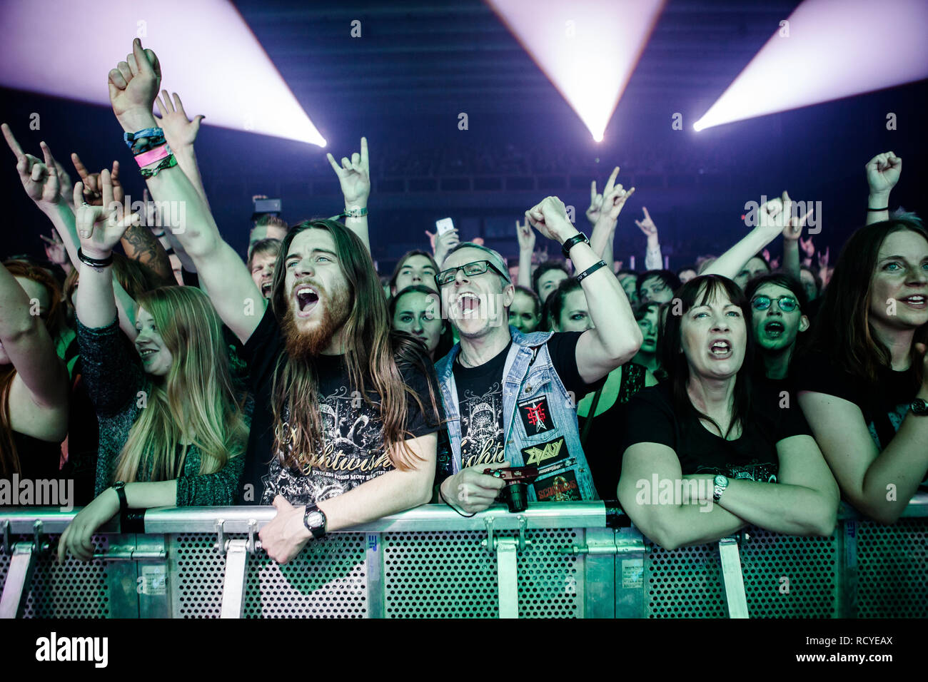 Amused heavy metal fans attend a live concert with the Finnish metal ...