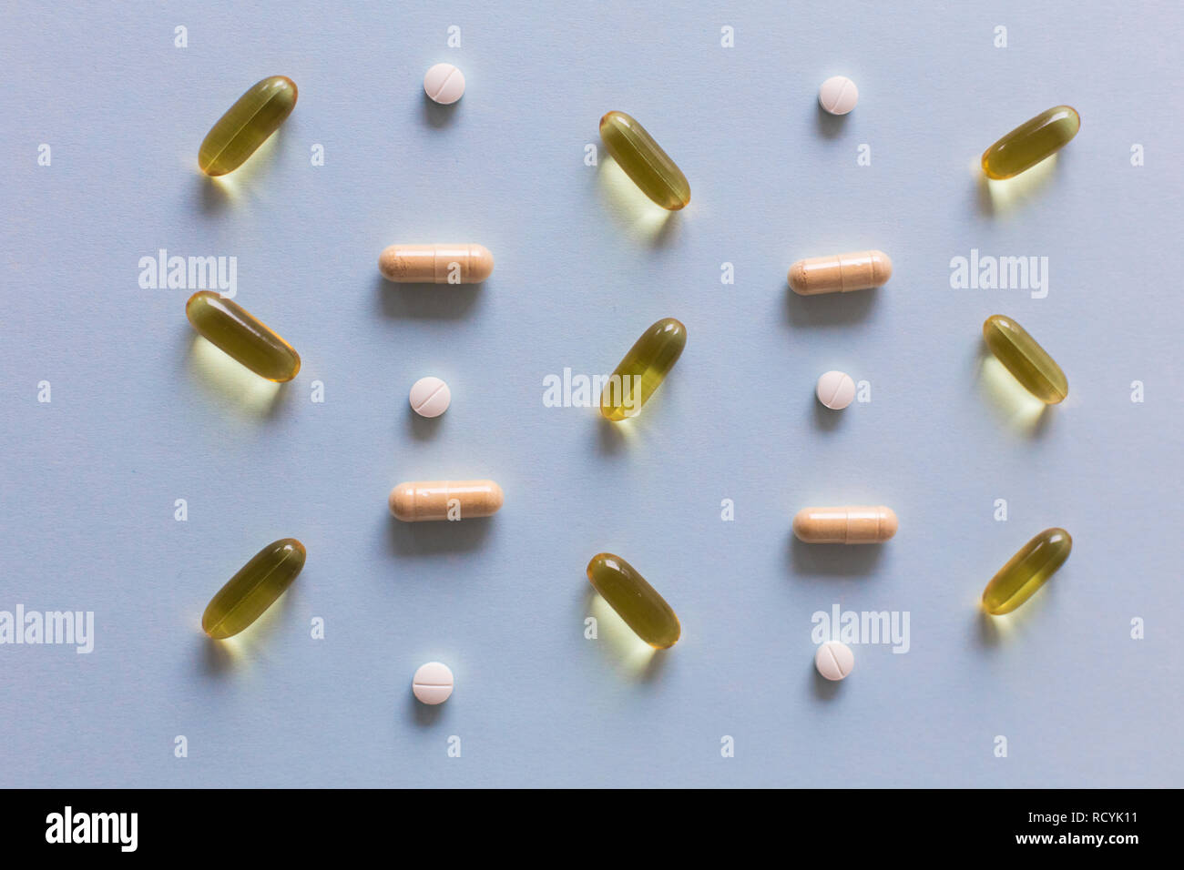 Various supplements on a light blue background Stock Photo - Alamy