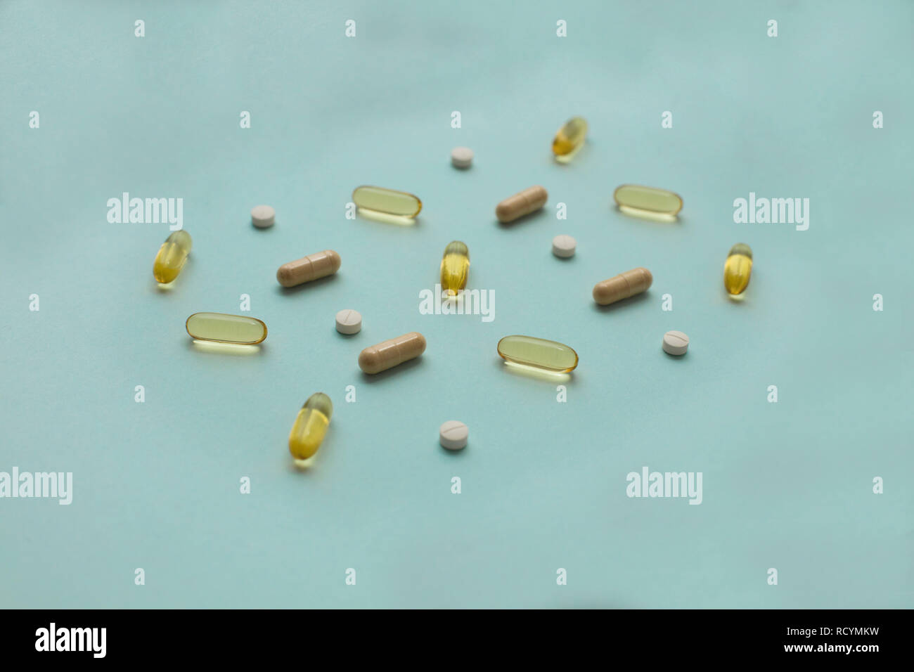 Various supplements on a light blue background Stock Photo - Alamy