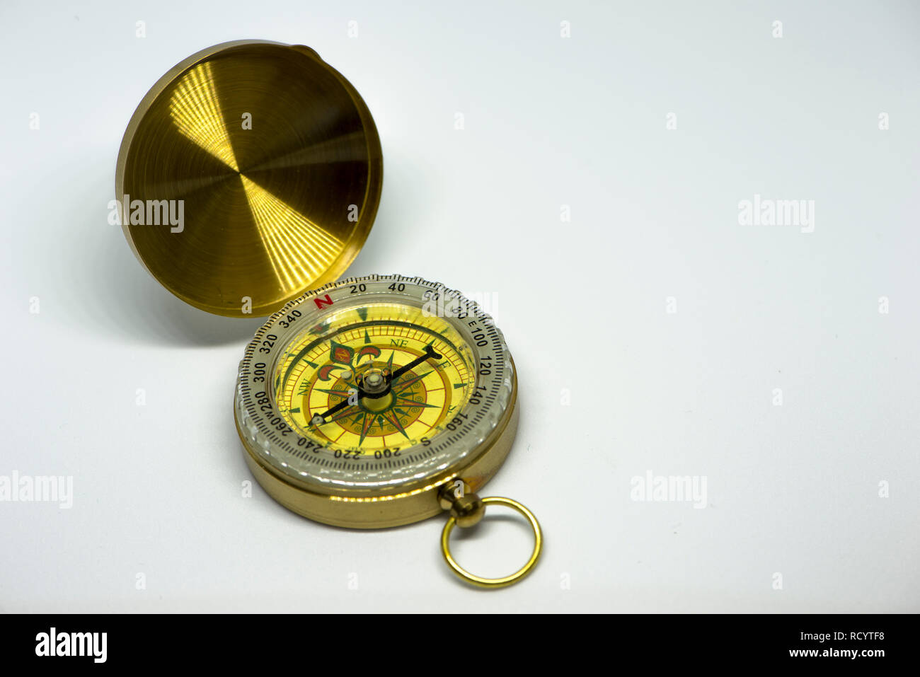 An old golden compass on a background of a white color Stock Photo - Alamy
