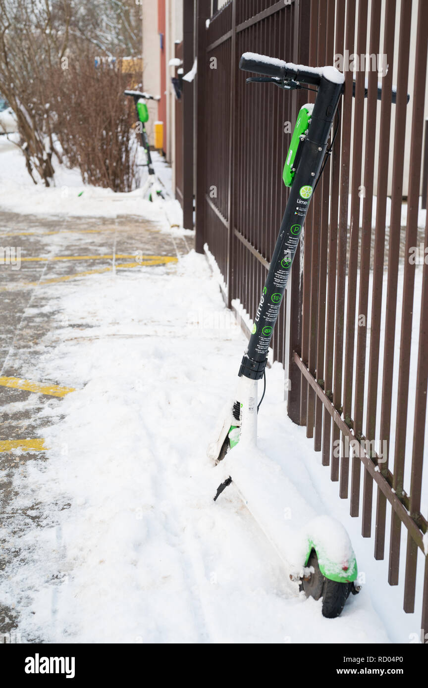 Lime electric scooter parked in snow Stock Photo - Alamy