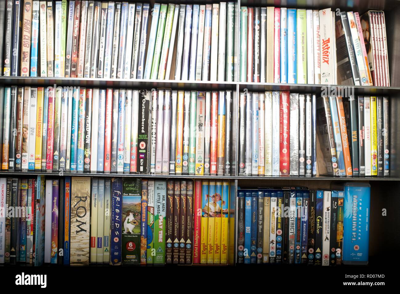 books and various media on home library shelves Stock Photo - Alamy