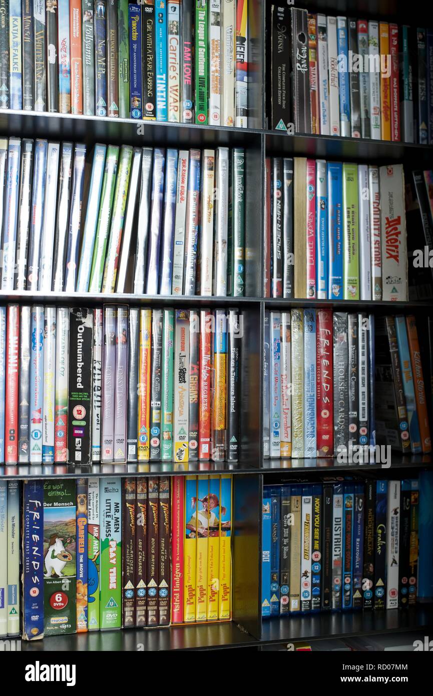 books and various media on home library shelves Stock Photo - Alamy