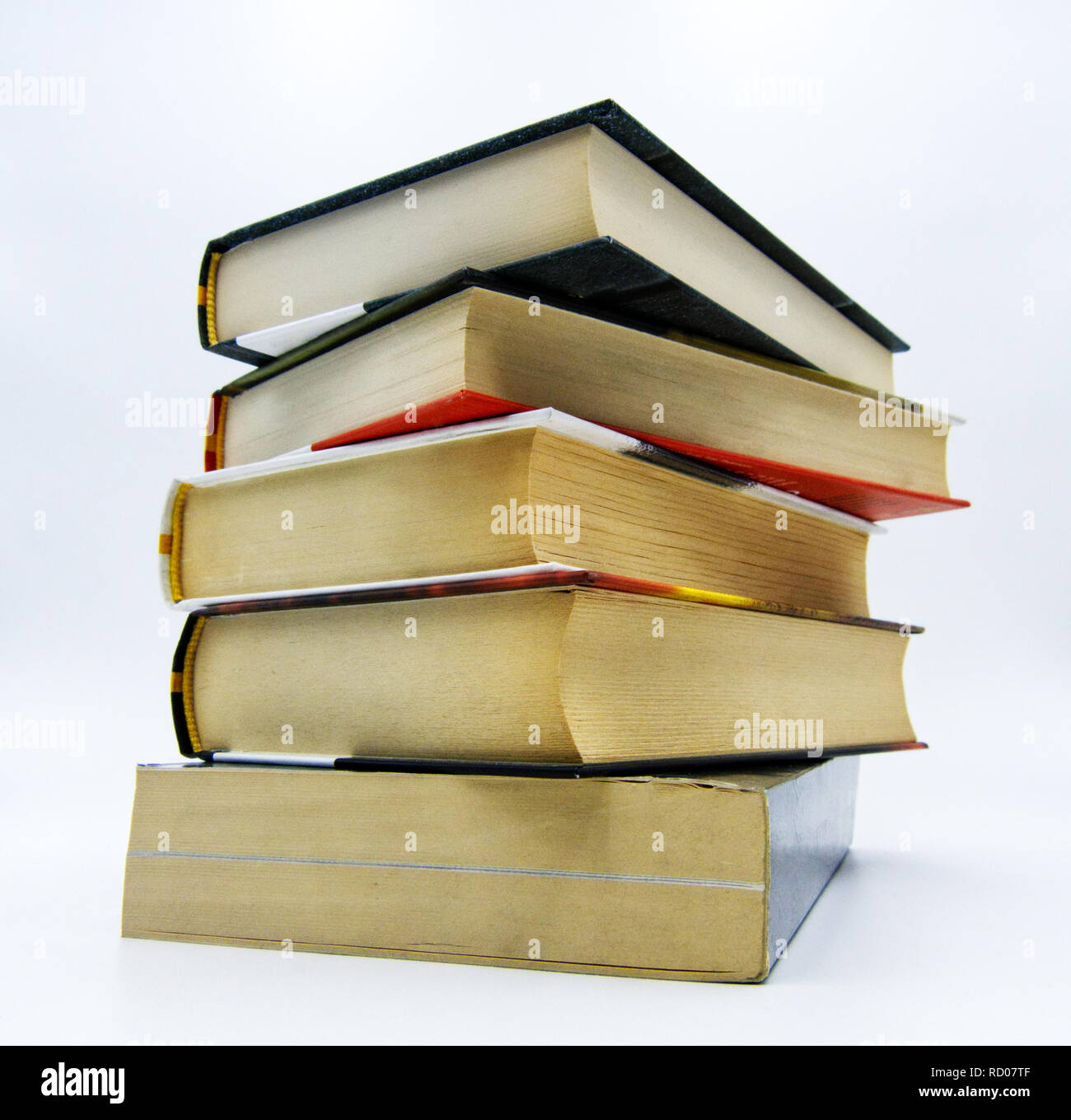 Pile of books on a table in white background Stock Photo - Alamy