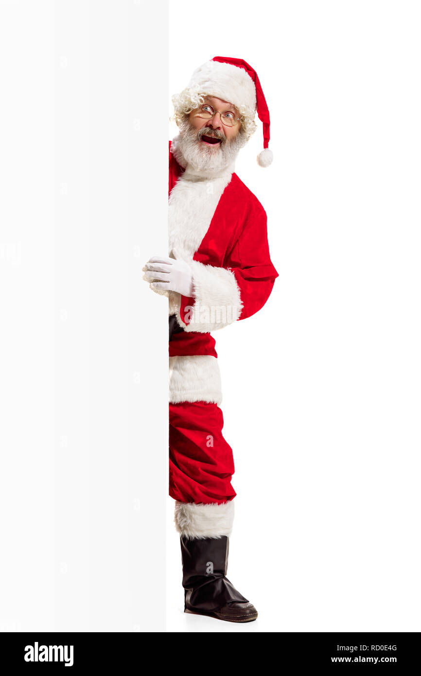 Happy surprised Santa Claus pointing on blank advertisement banner ...