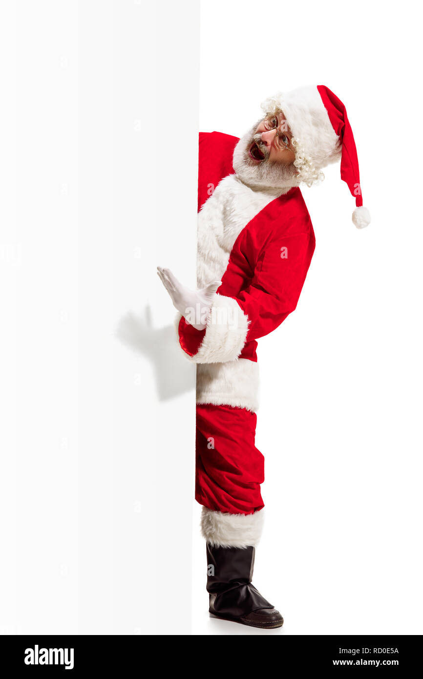 Happy surprised Santa Claus pointing on blank advertisement banner ...