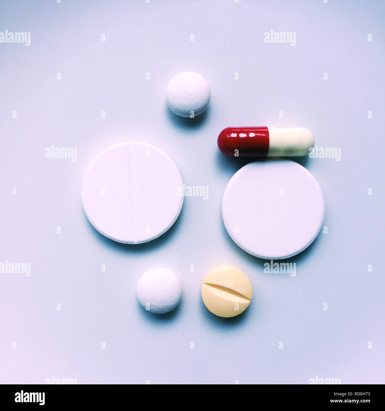 Six pills on a white background Stock Photo - Alamy