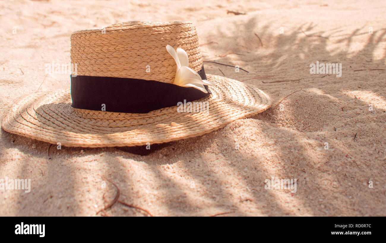 Straw hat on sand, sun protection concept. Still life with a hat and ...