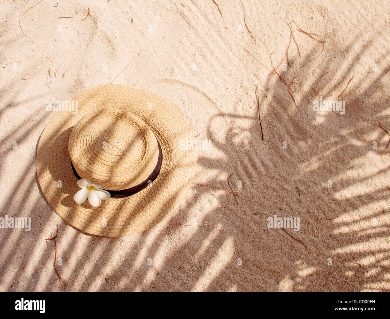 Straw hat on sand, sun protection concept. Still life with a hat and ...