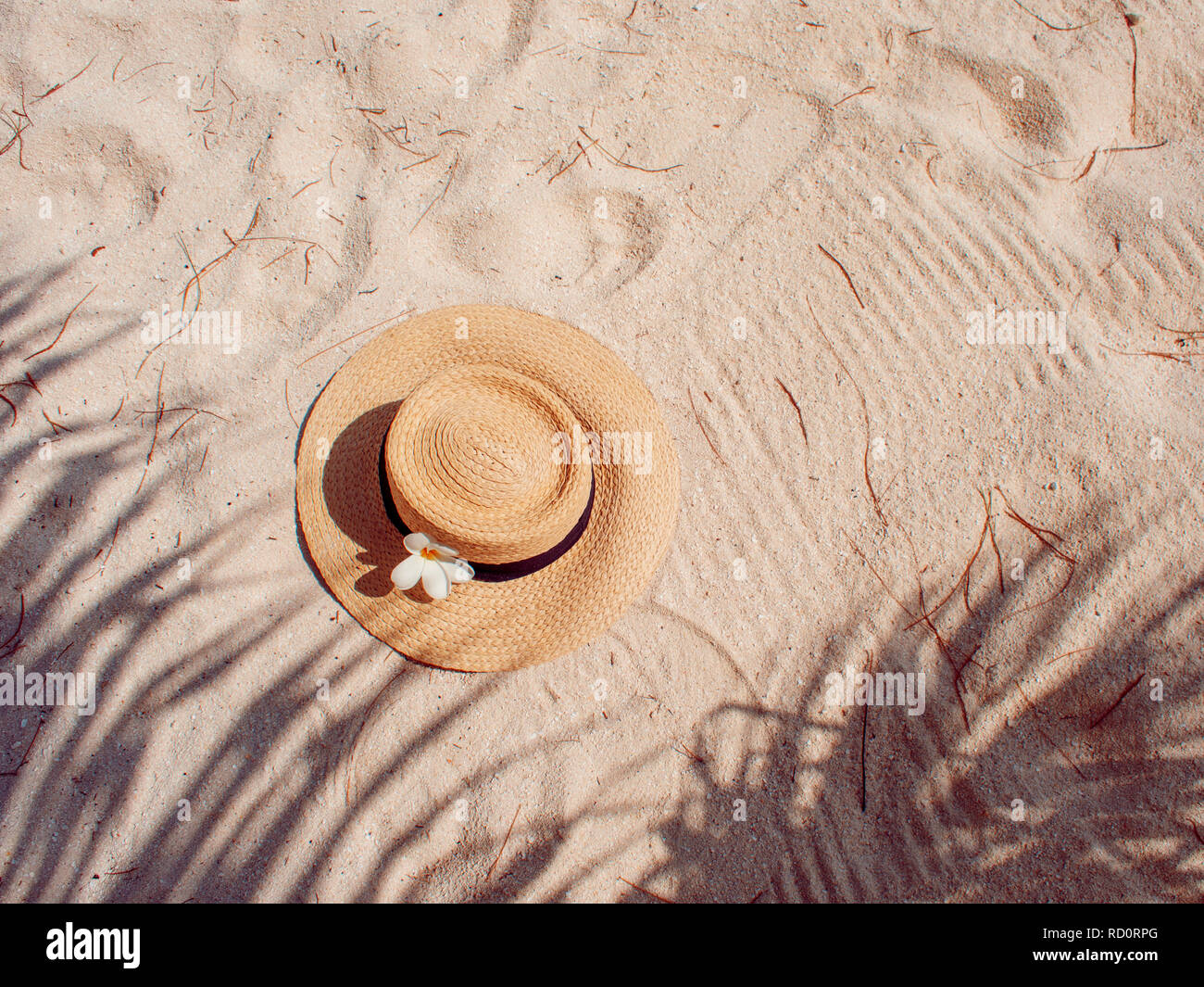 Straw hat on sand, sun protection concept. Still life with a hat and ...