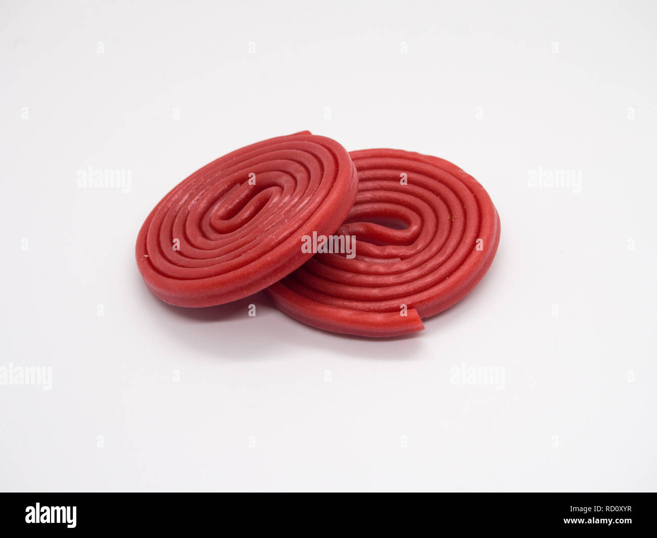 Red licorice on white background Stock Photo - Alamy
