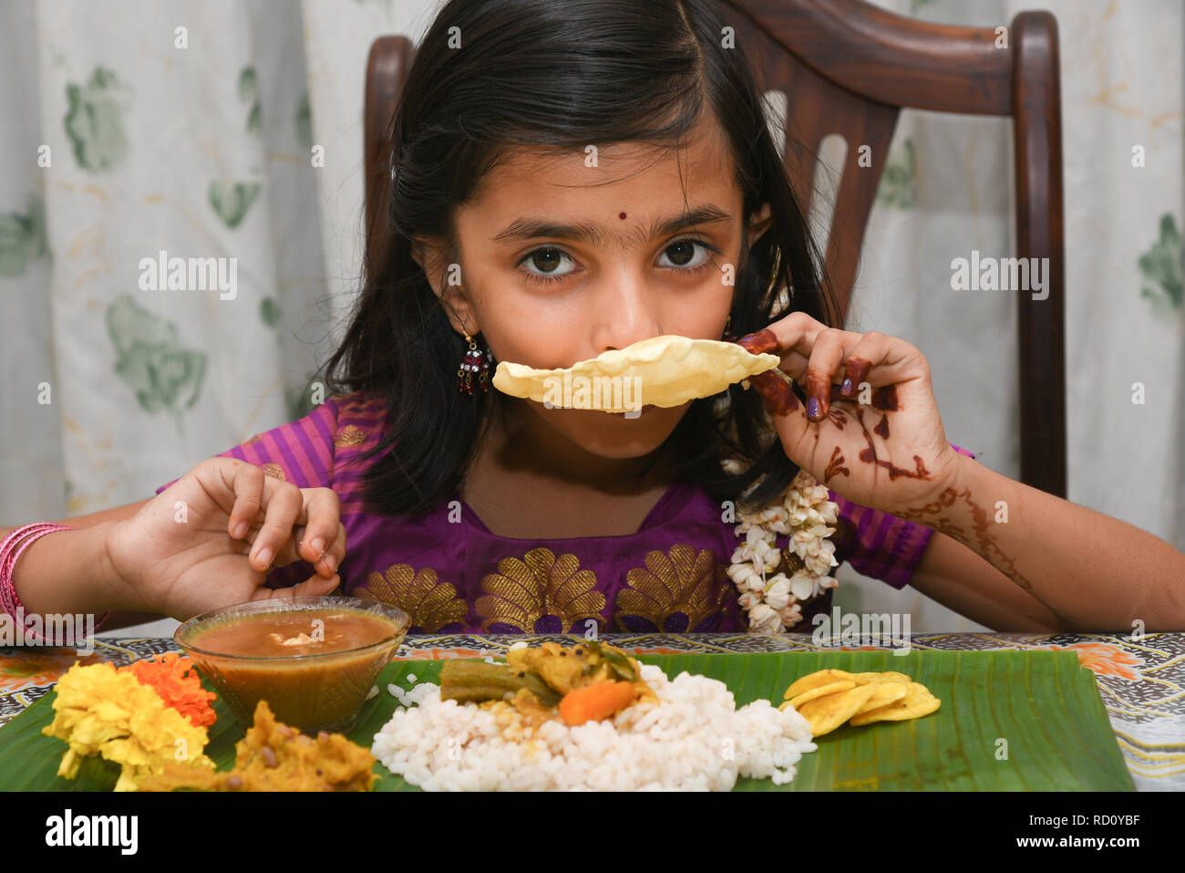 Indian girl child eating Onam Sadhya grand feast served on banana leaf ...