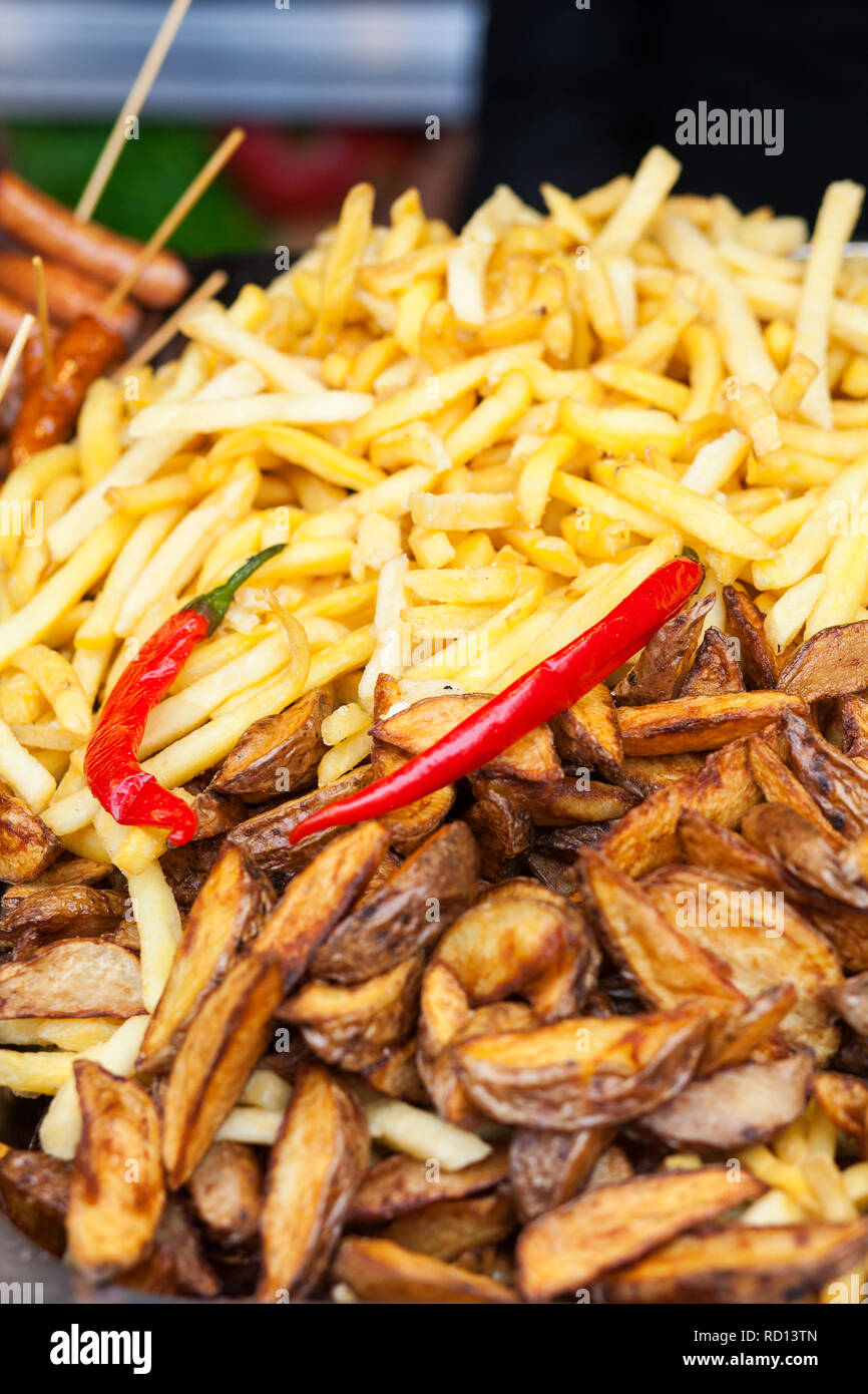 In European city a lot of delicious fries and baked potatoes on the ...