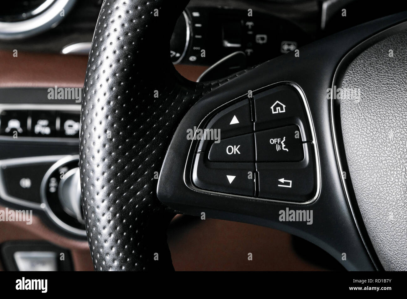 Media and navigation control buttons on a steering wheel of a Modern ...