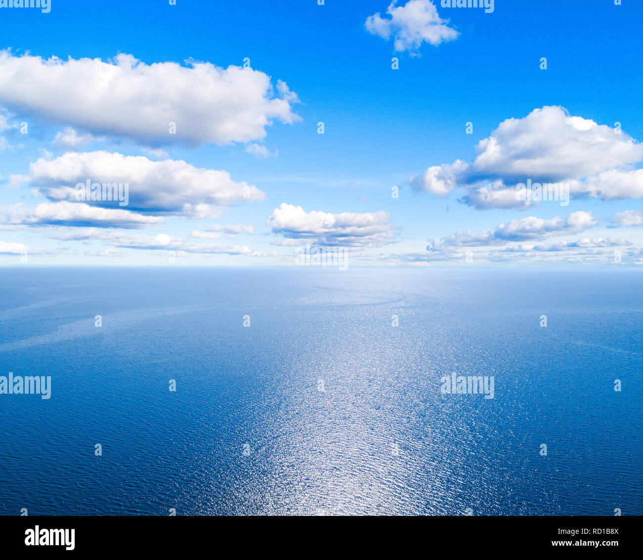 Aerial view of a blue sea water background and sun reflections. Aerial ...