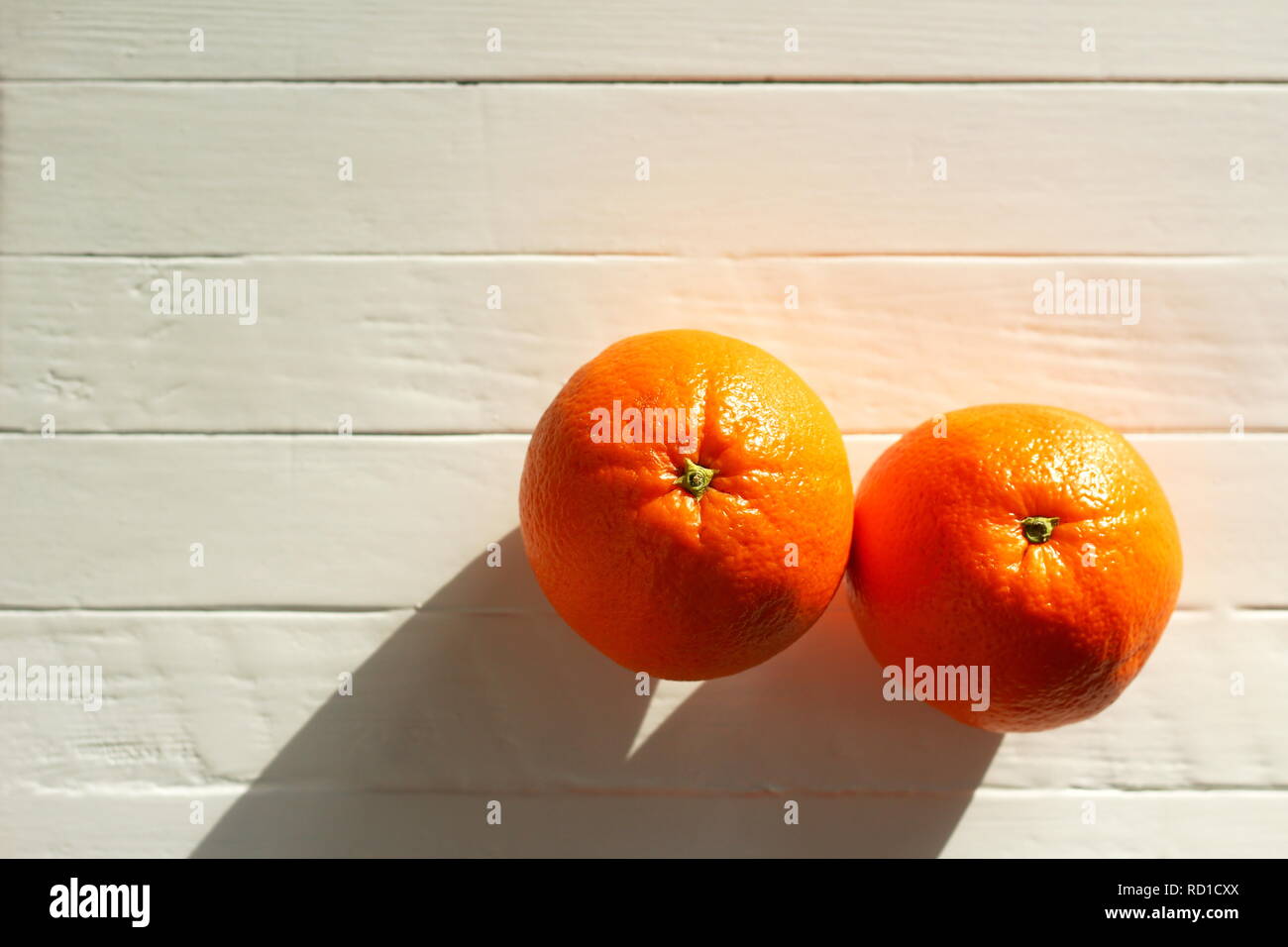 Two oranges on a white table, view from above Stock Photo - Alamy