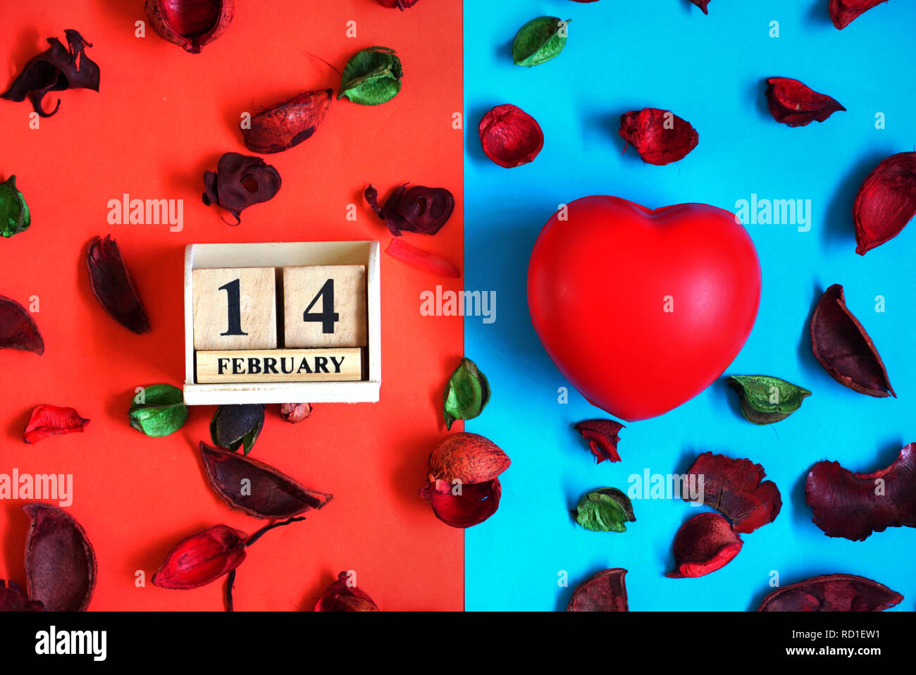 Red heart and wood cube calendar on valentine day decorate with red dry ...
