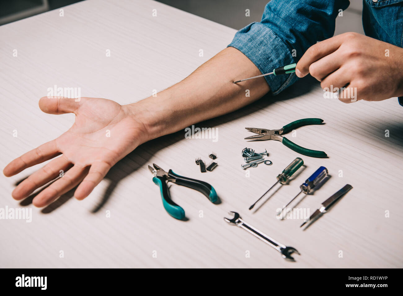 cropped view of man repairing hand with metallic tools Stock Photo - Alamy