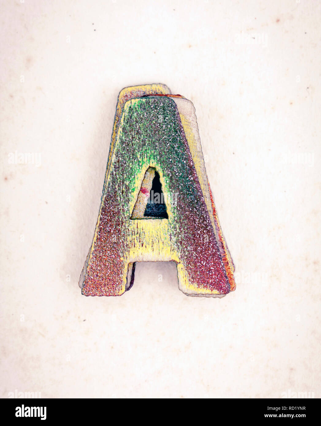 a pile of old painted wooden letters A,s on old worn paper Stock Photo ...