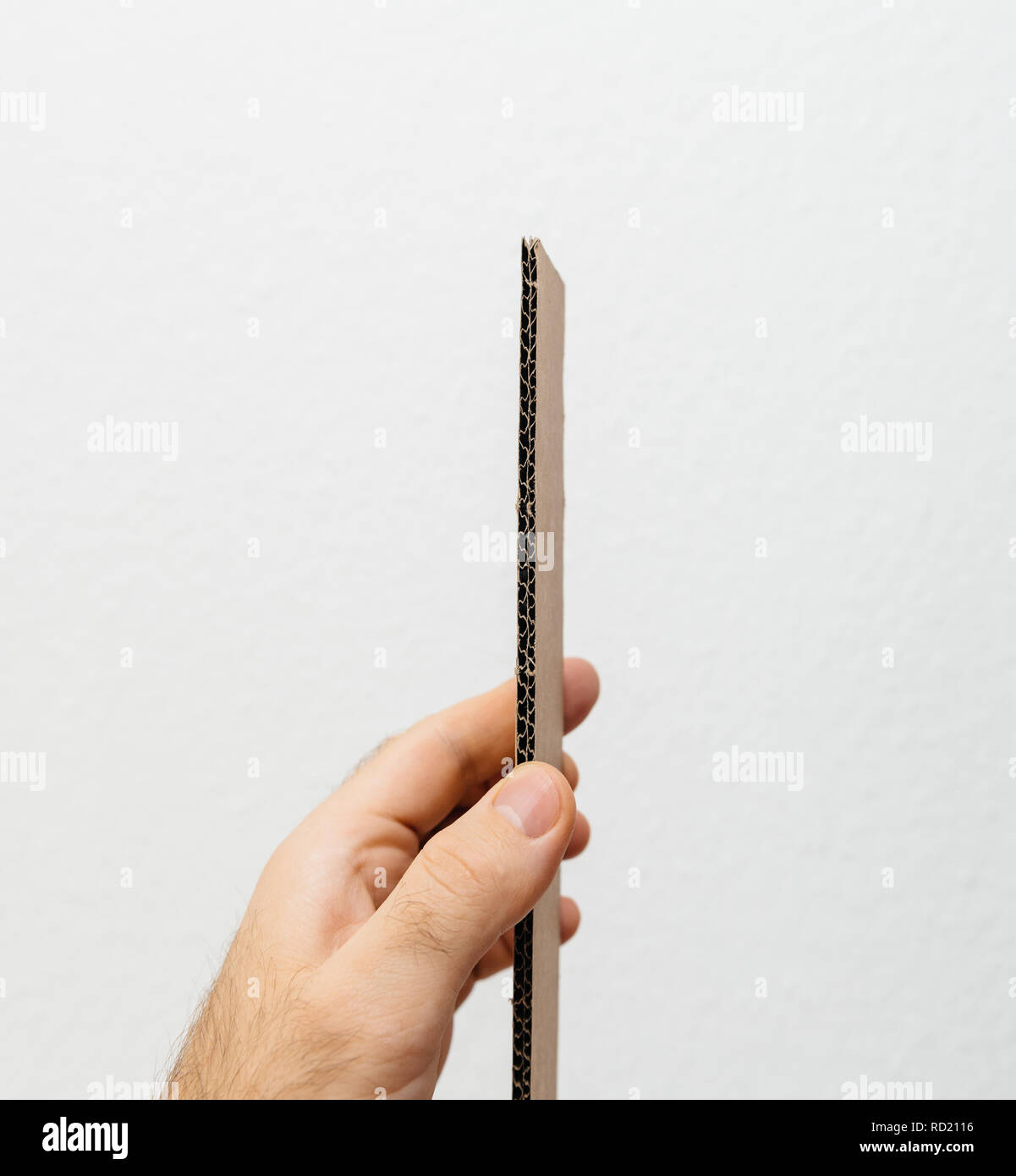 Factory worker male hand holding against white background a thin ...