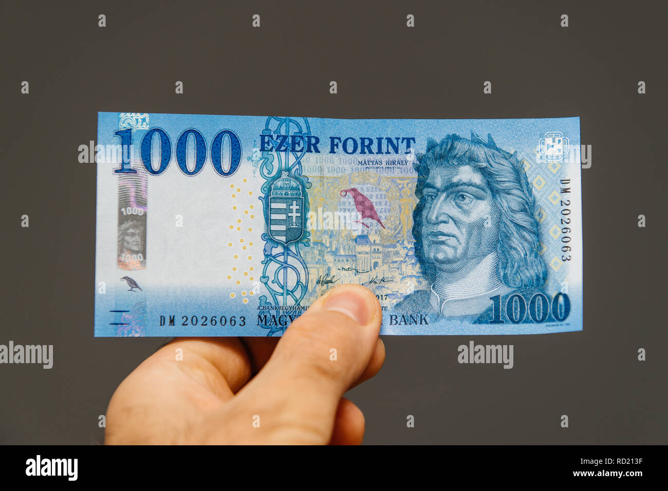 PARIS, FRANCE - APR 1, 2018: Man holding against gray background paper ...
