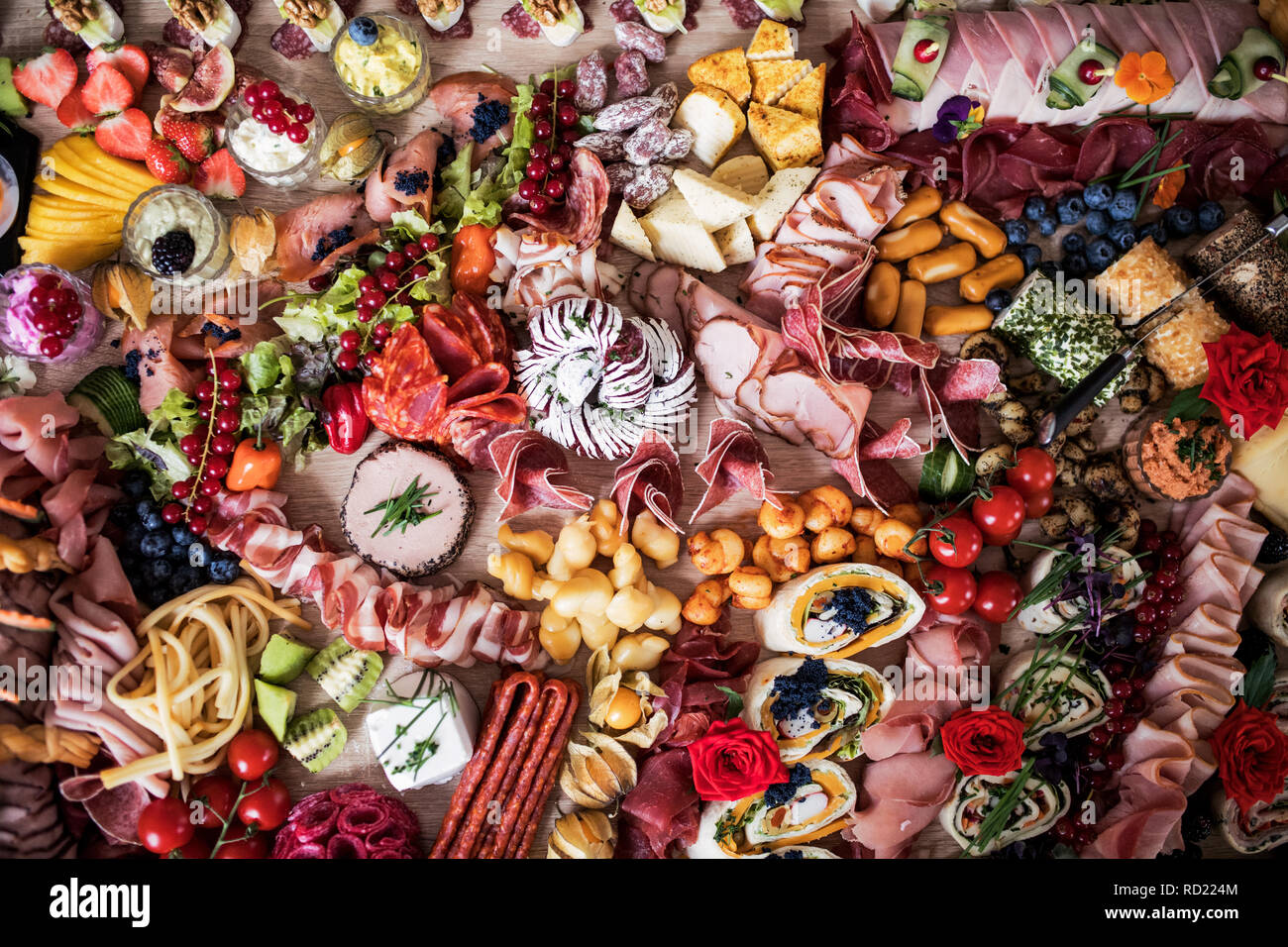 A top view of various food and snacks on a tray on a indoor party, a ...