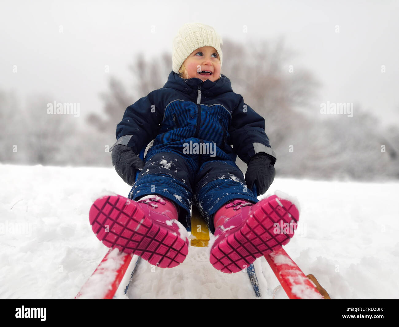 Childhood, sledding, leisure concept. Parent carrying happy little kid ...