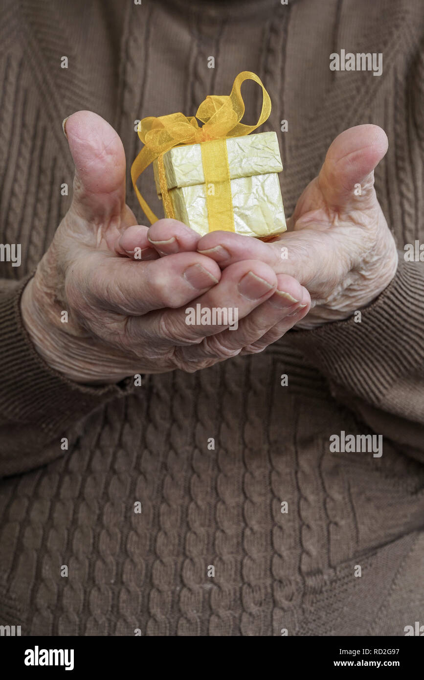 Grandma holding wrapped gift hi-res stock photography and images - Alamy