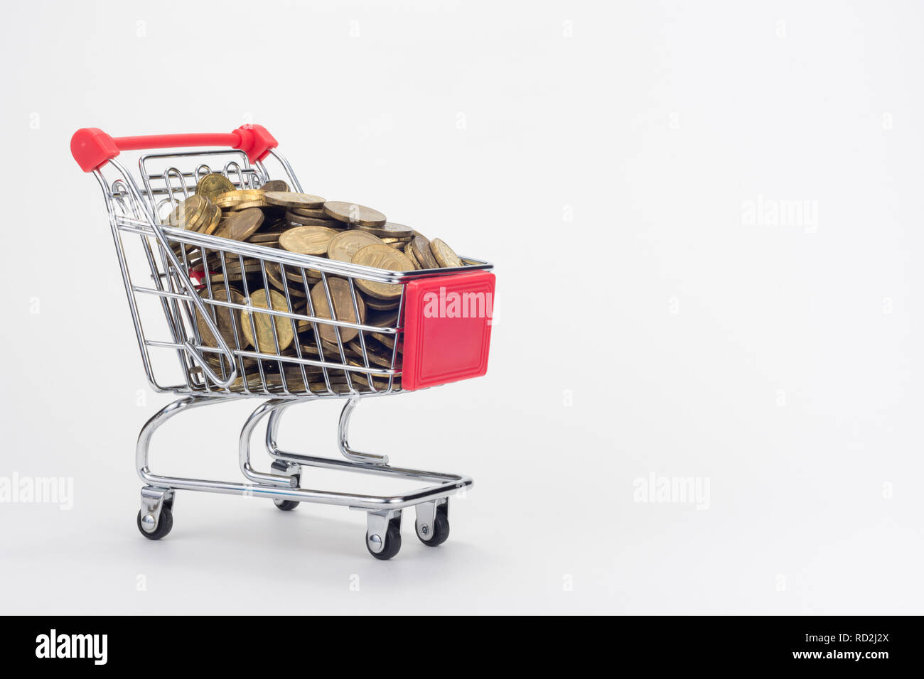 Grocery shopping cart filled with coins Stock Photo - Alamy