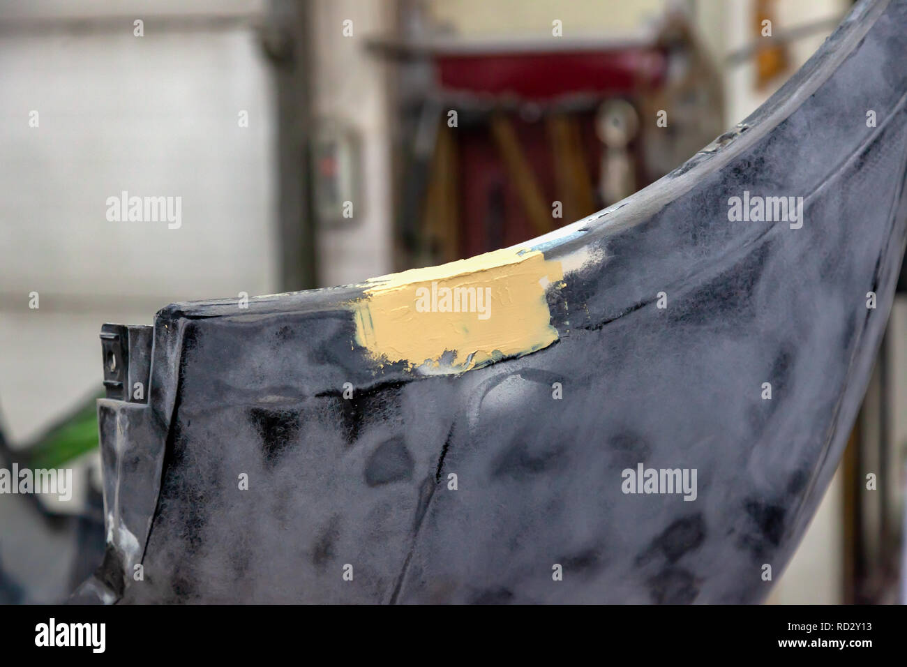 Detail of the iron damaged car bumper is repaired in the workshop using ...
