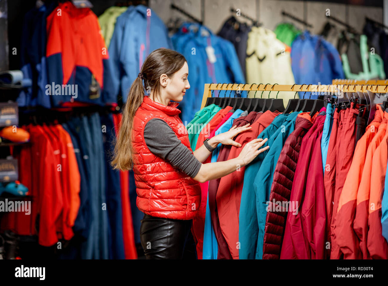 Woman hanging coat up hi-res stock photography and images - Alamy