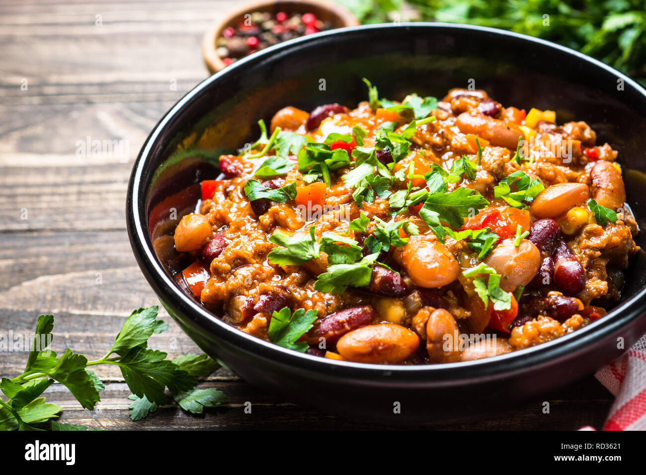 Chili con carne from meat, beans and vegetables on dark wooden table ...