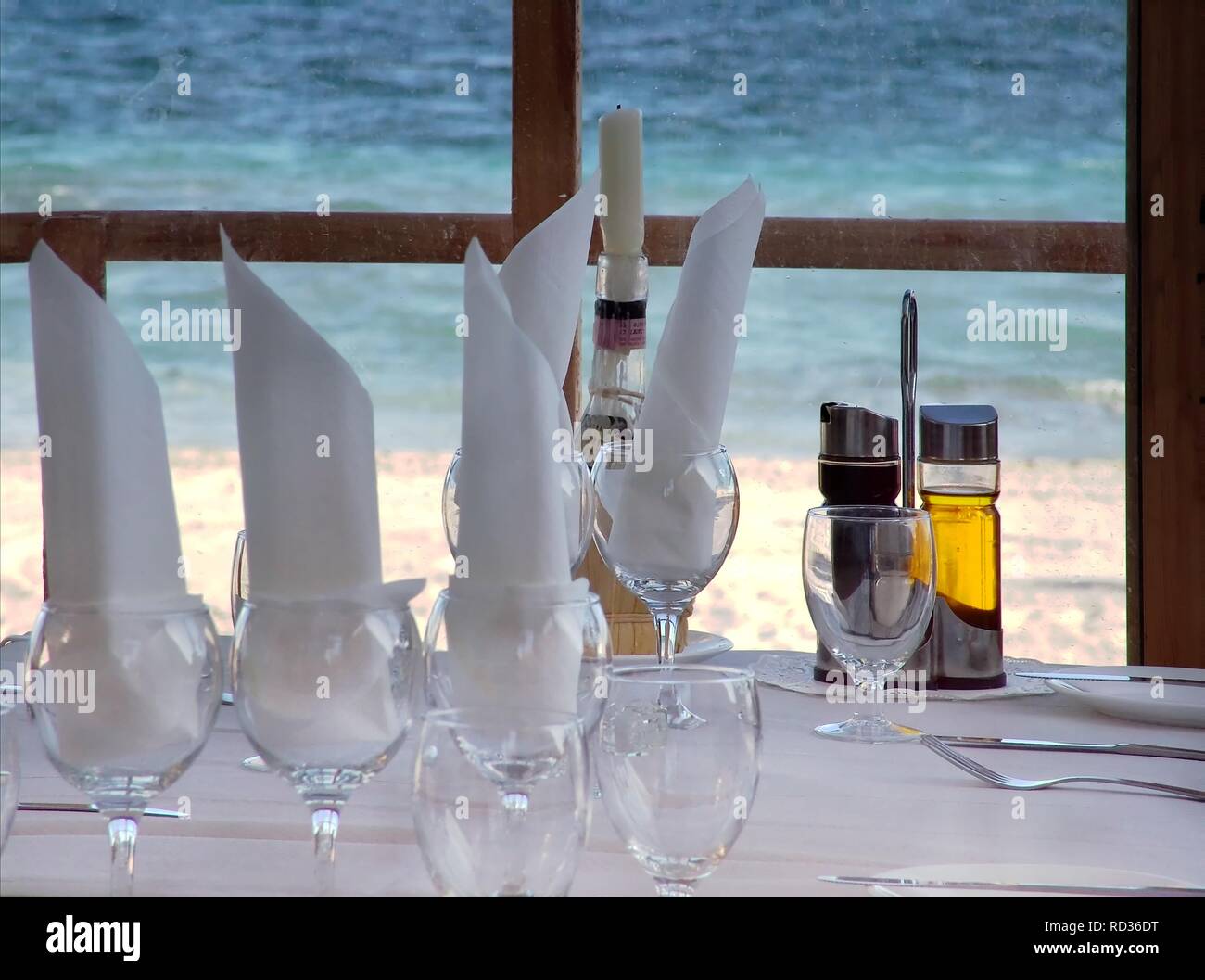 Seaside restaurant table set with beach view Stock Photo - Alamy