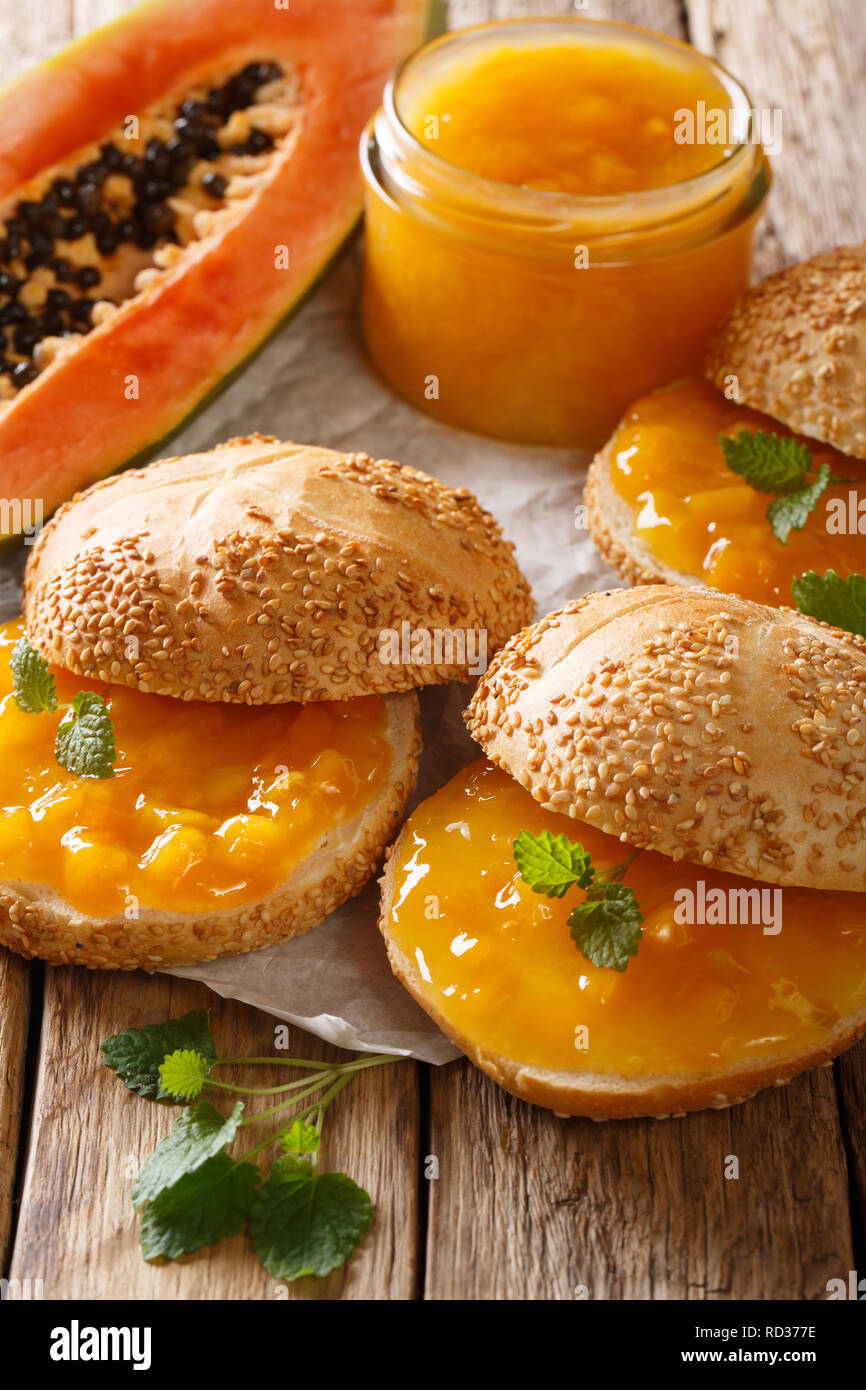 Sweet buns with papaya jam and cream cheese decorated with mint close ...