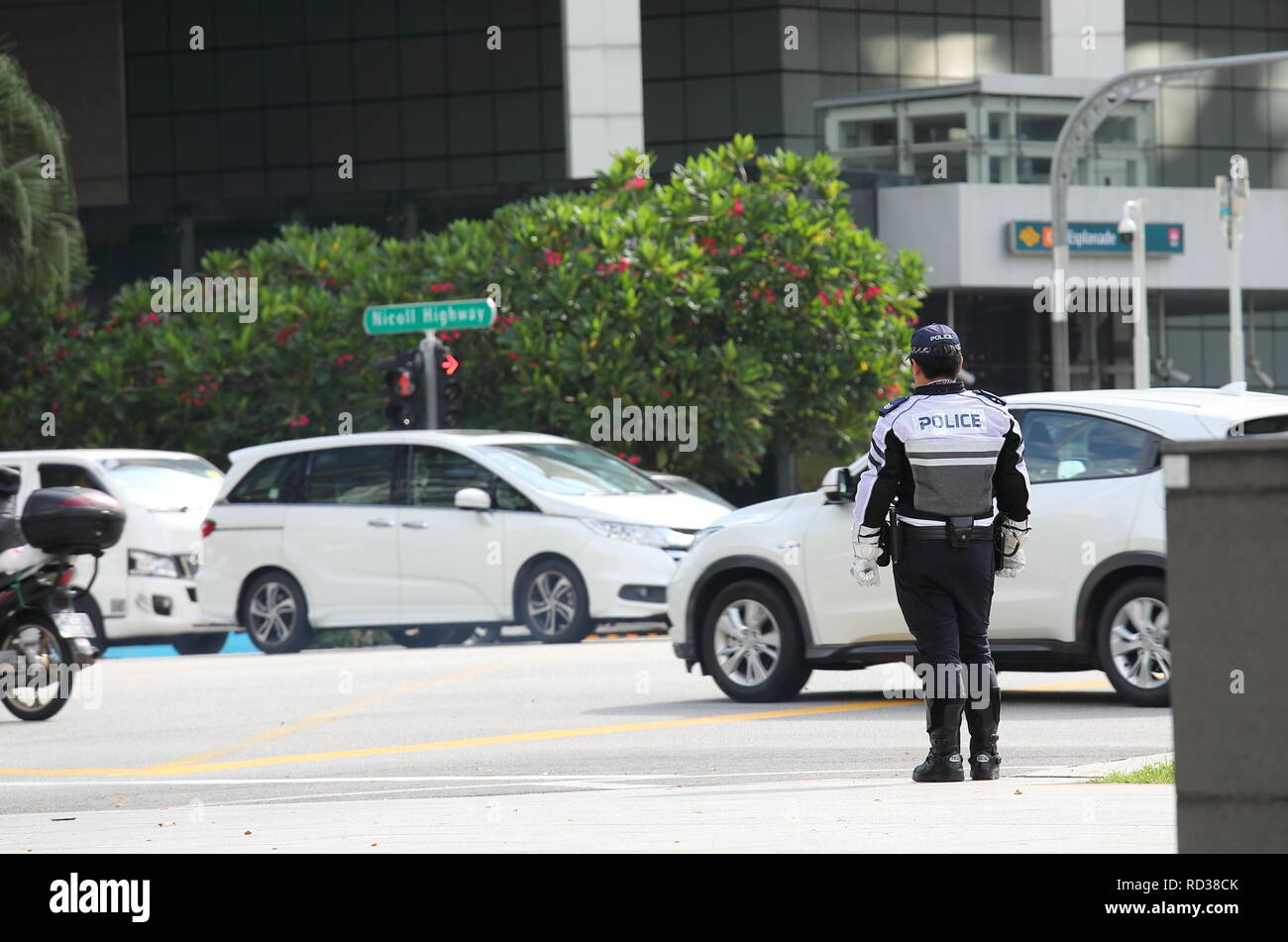 Police officer watch downtown traffic in Singapore Stock Photo - Alamy