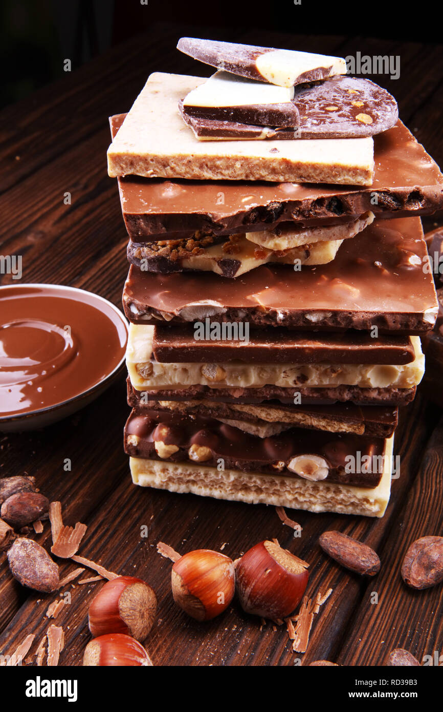 Chocolate bars on table with chocolate tower. Chocolate and nuts and ...