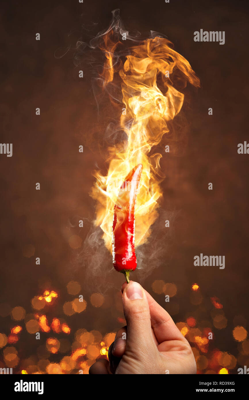 Hot chili pepper surrounded by fire and flames Stock Photo - Alamy