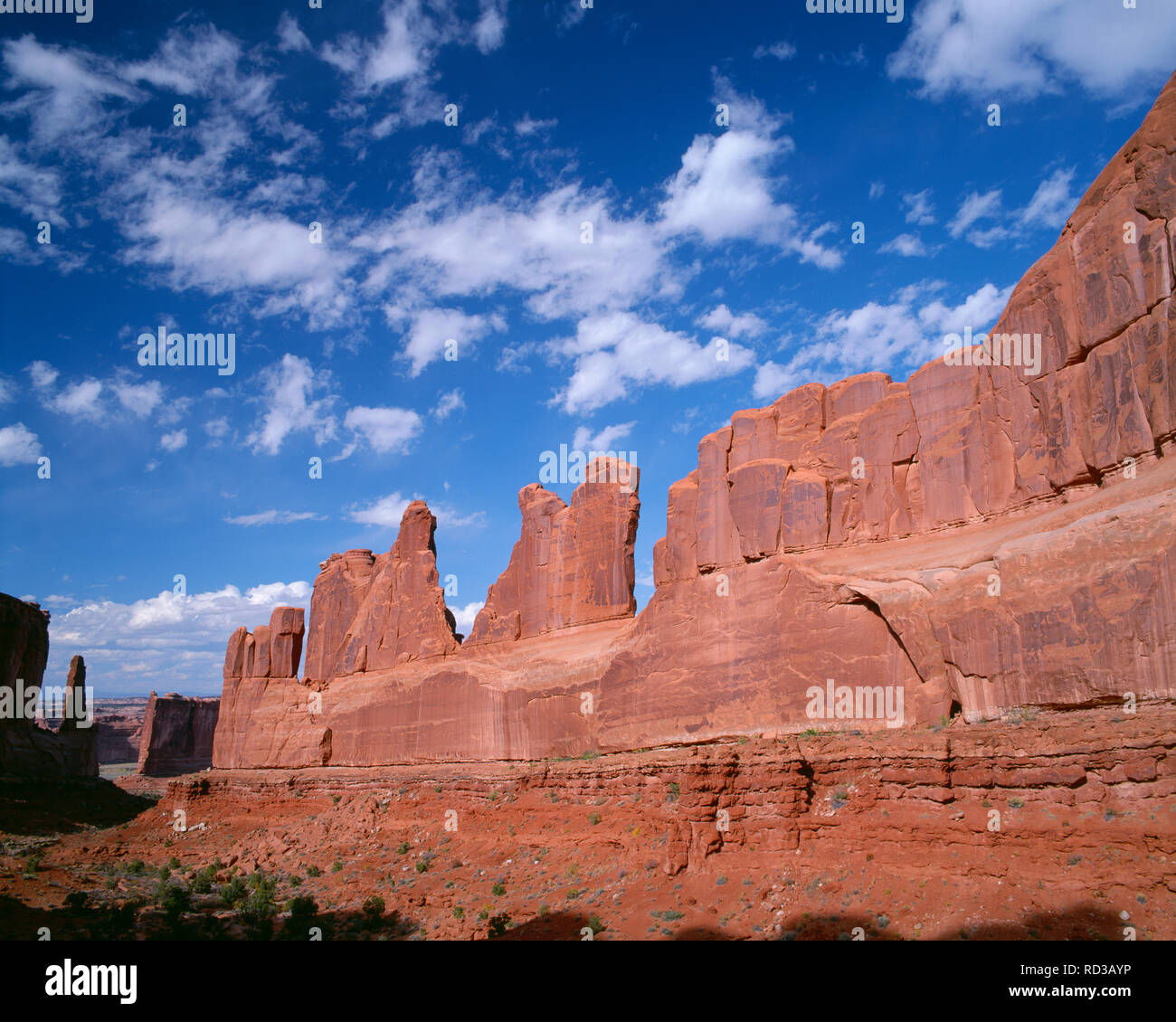 USA, Utah, Arches National Park, Cumulus clouds gather over steep fins ...
