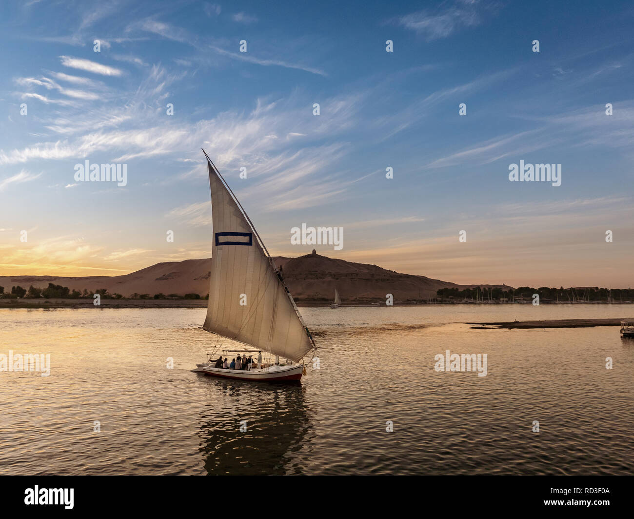 Tourist taking a ride in a Felucca boat in Luxor Egypt on the NIle ...