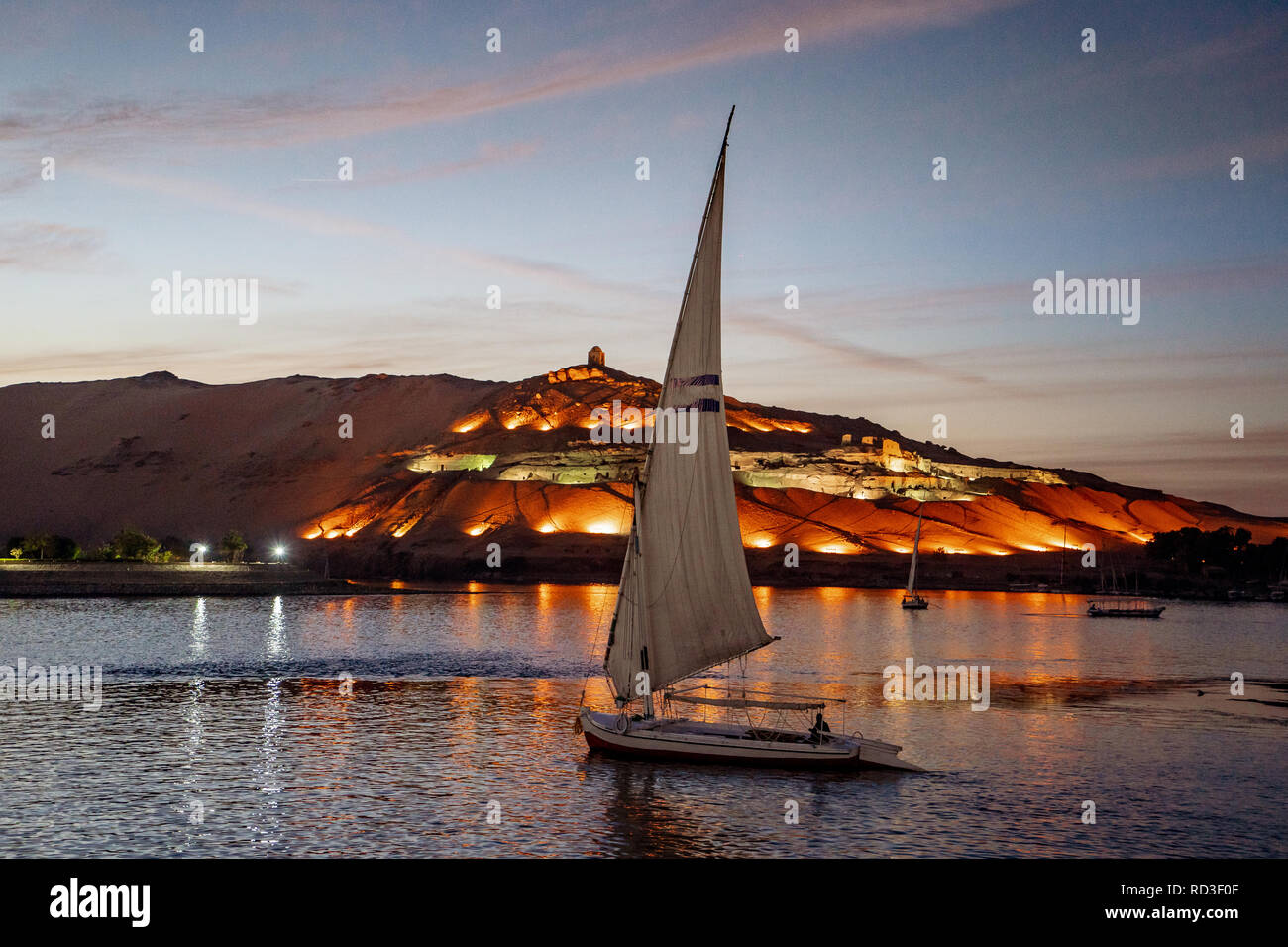 Sunset in Aswan Egypt with Felucca boat on the Nile river Stock Photo ...