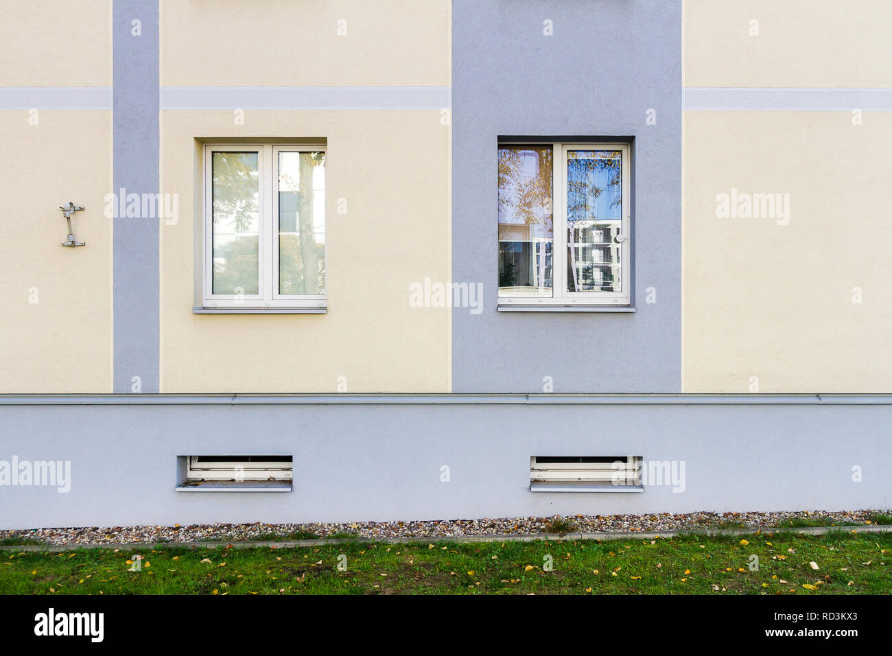 Modern wall with some windows and a grass. Architectural detail ...