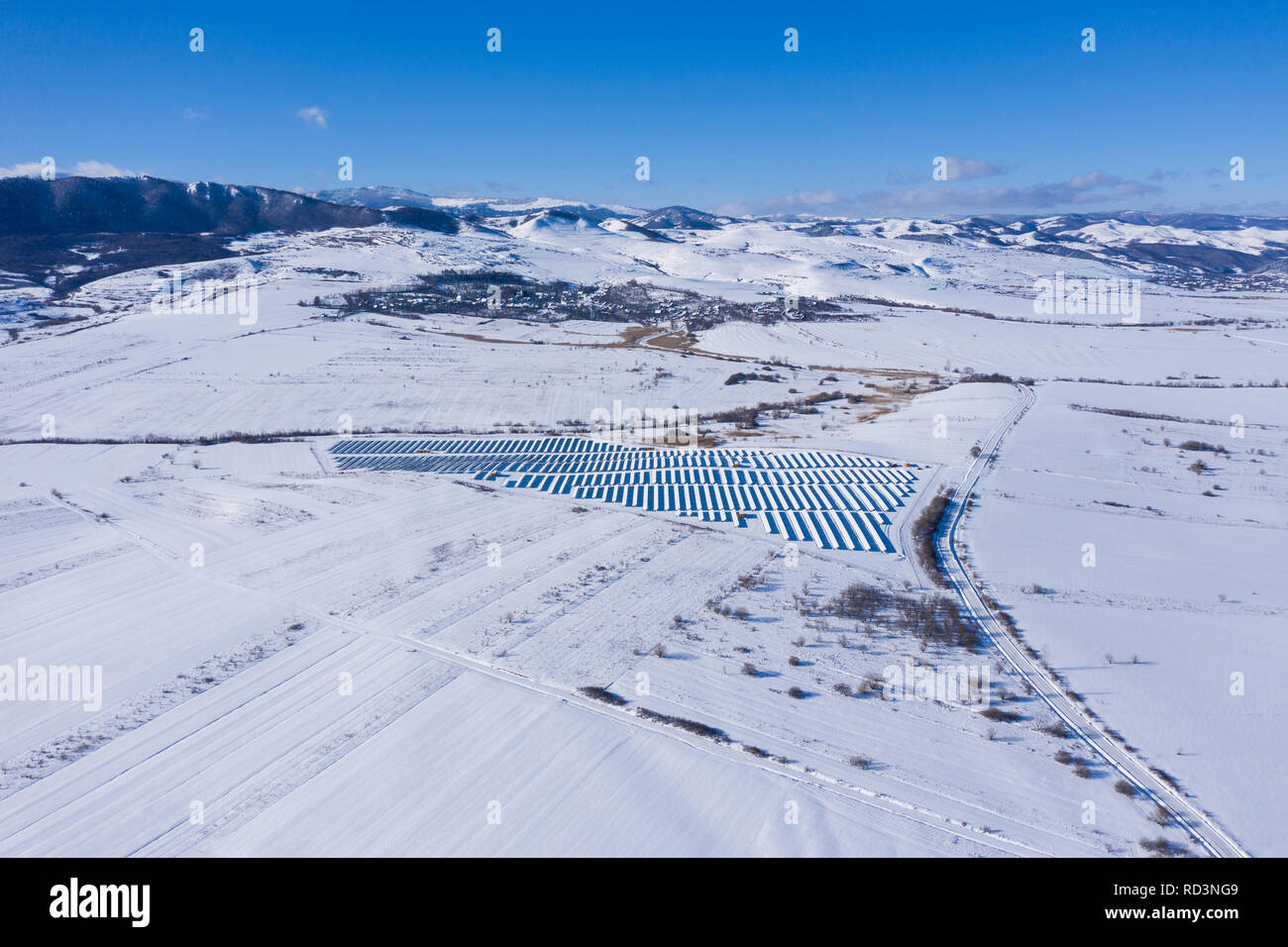 Aerial drone view of snow covered solar panel park, photovoltaic power ...
