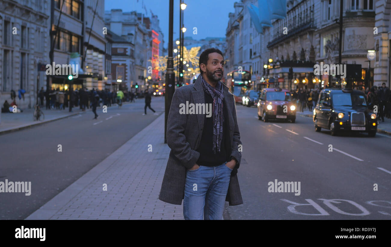 Man on a sightseeing trip in the streets of London at Piccadilly Circus ...