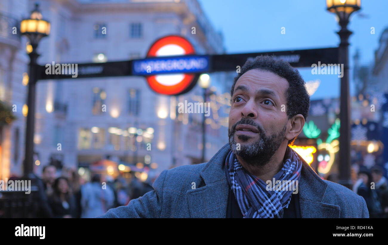 Man on a sightseeing trip in the streets of London at Piccadilly Circus ...