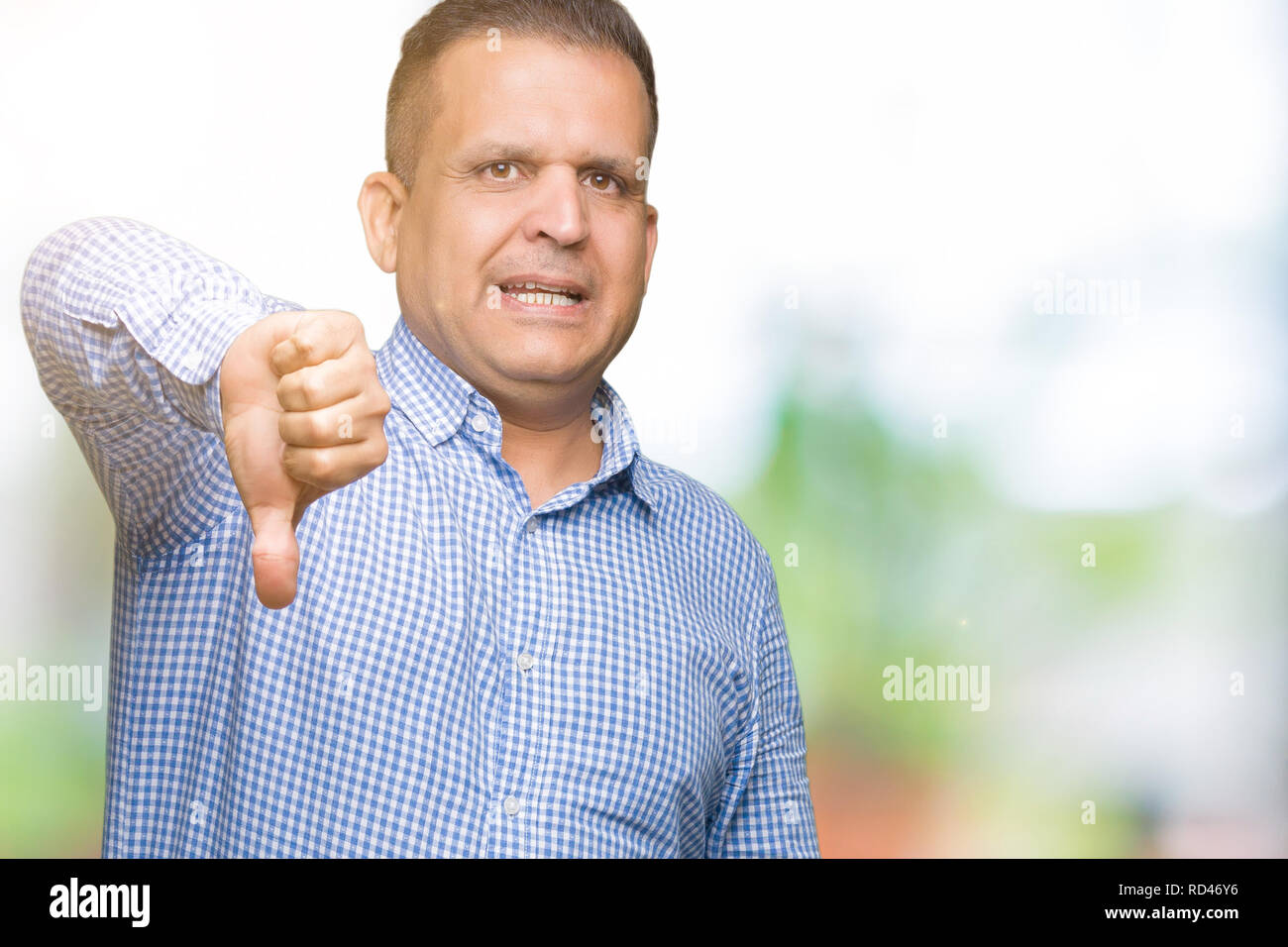 Middle age arab business man over isolated background looking unhappy ...